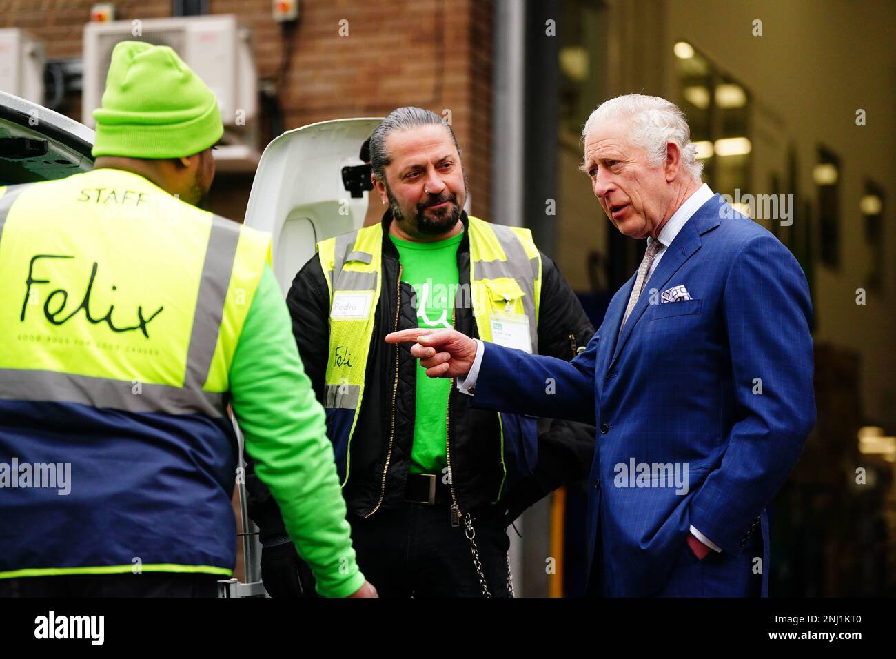 King Charles III talking to food bank delivery drivers during a visit ...