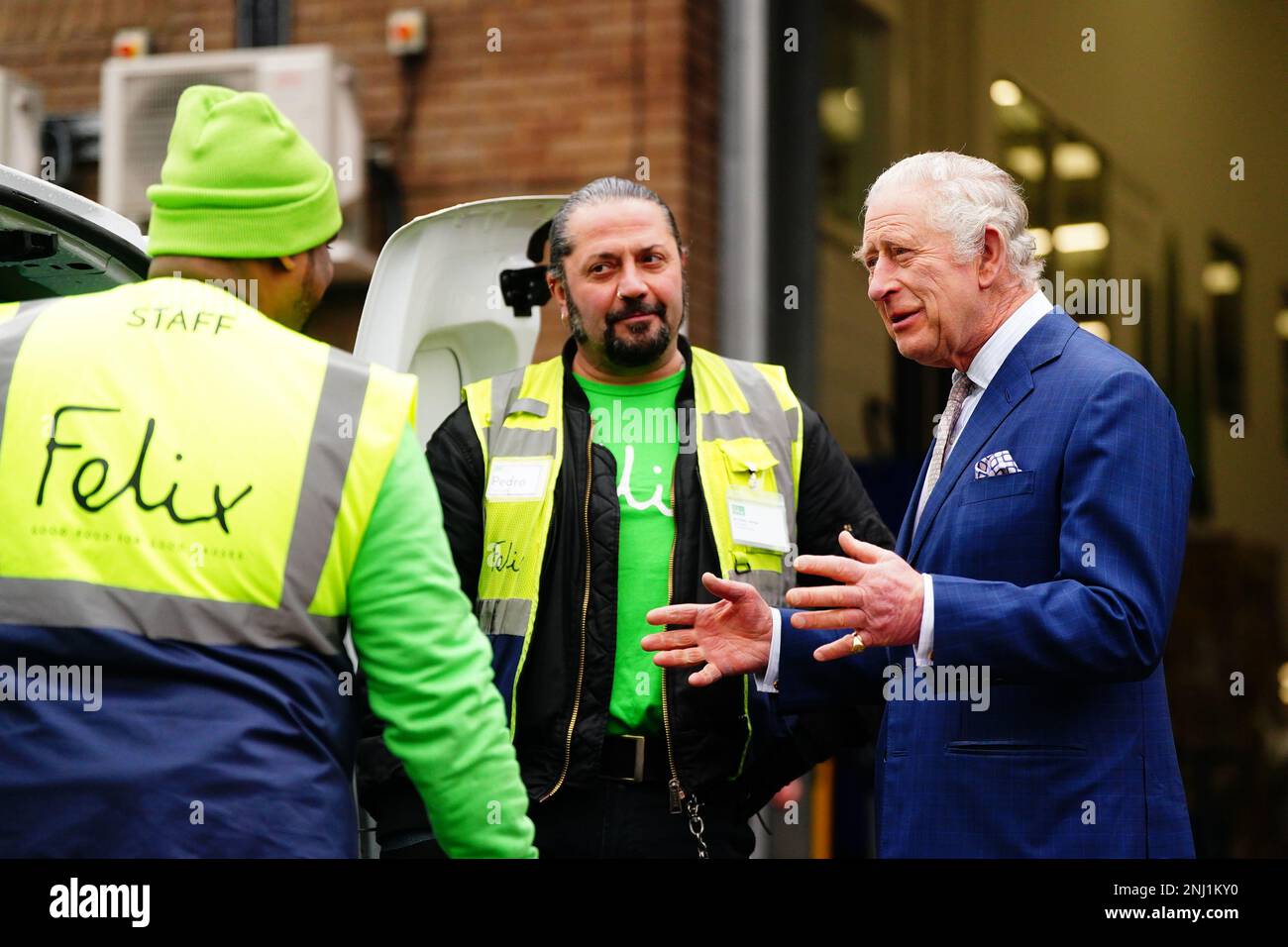 King Charles III talking to food bank delivery drivers during a visit ...