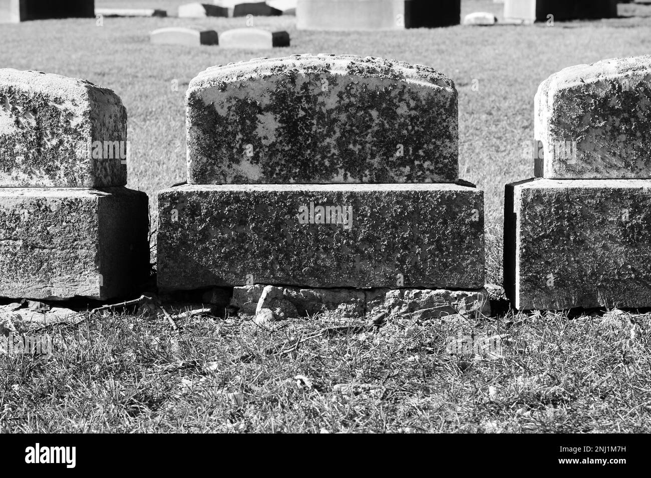 A worn and weathered old tombstone with a blank epitaph and room for ...