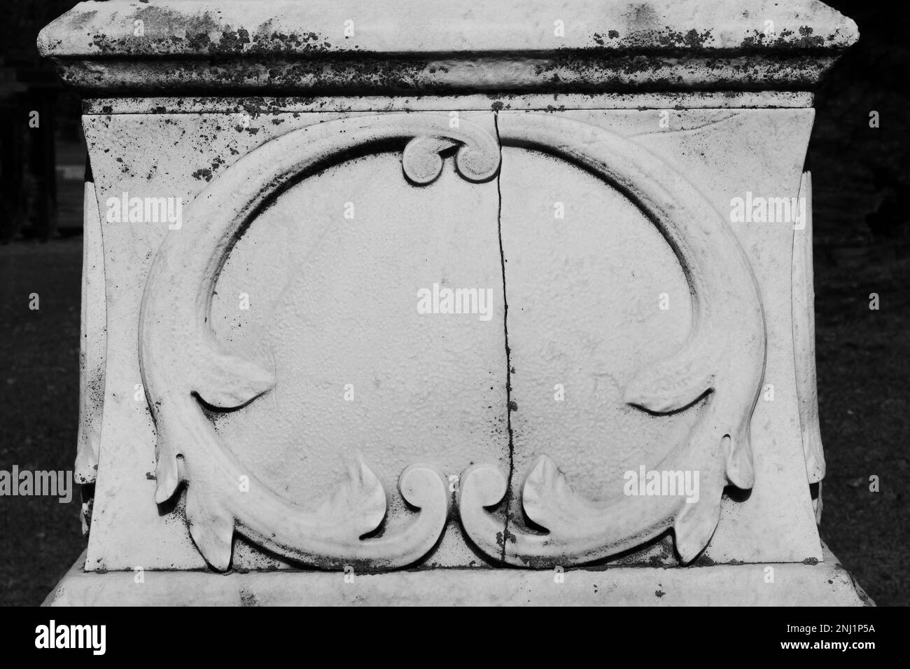 A worn and weathered old tombstone with a blank epitaph and room for ...