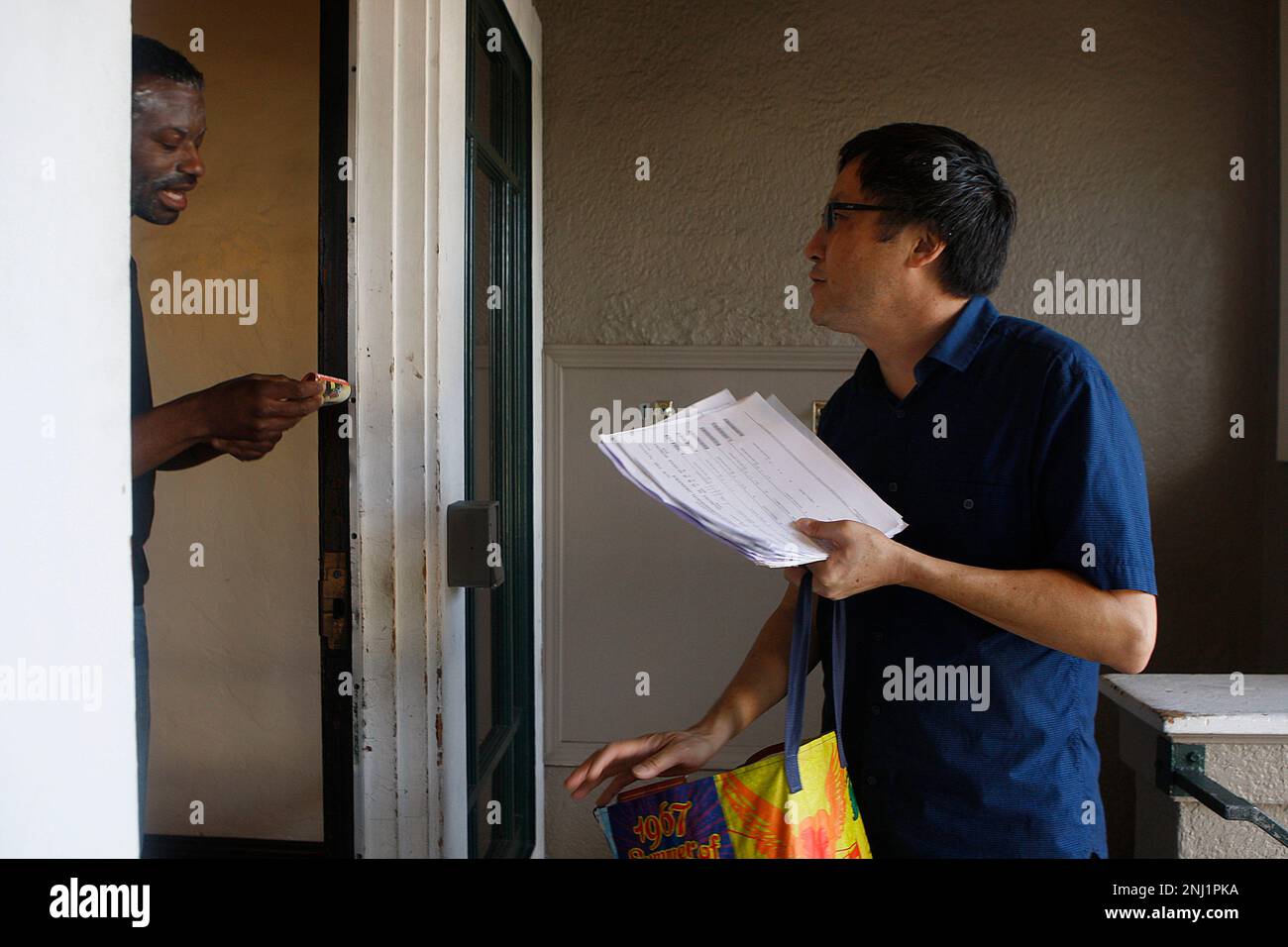 Executive director Gordon Mar of Jobs with Justice visits a voter ...