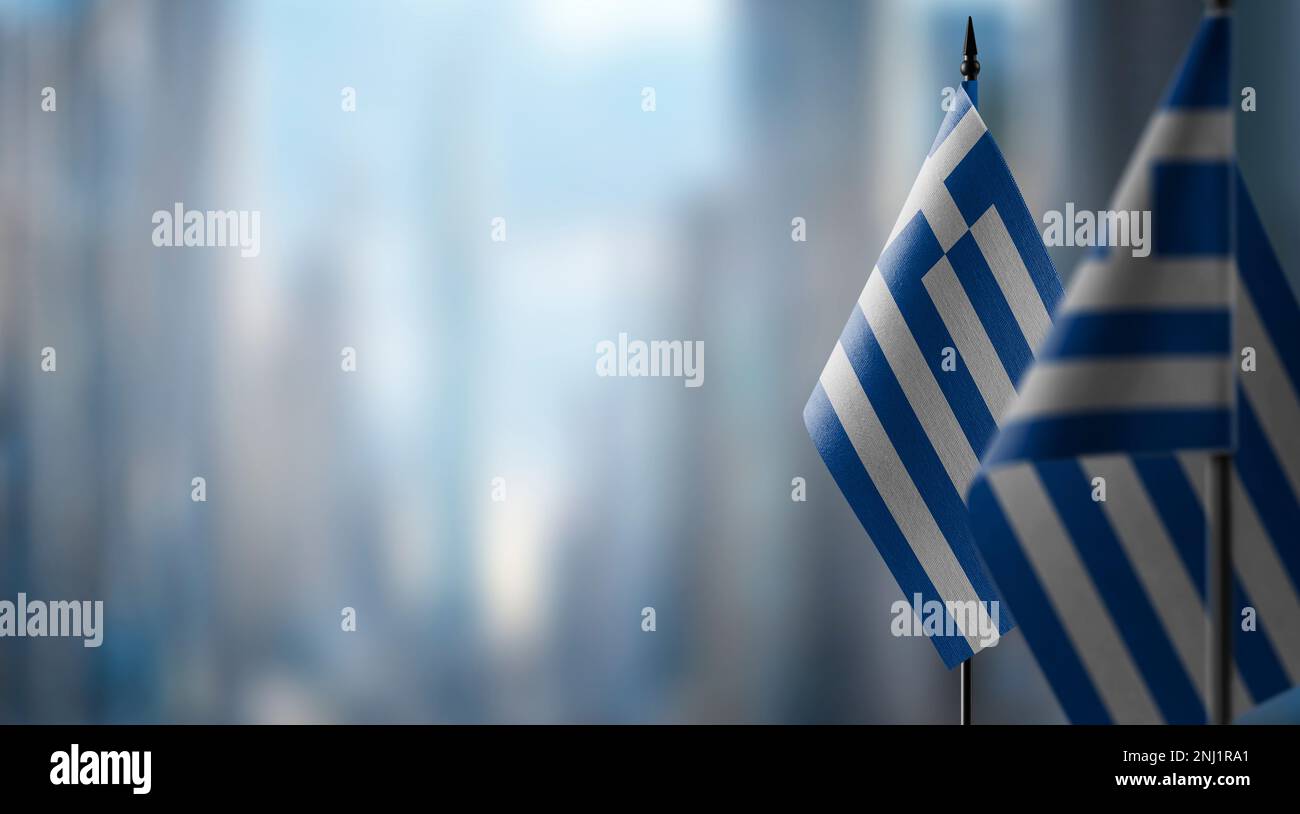 Small flags of the Greece on an abstract blurry background Stock Photo ...