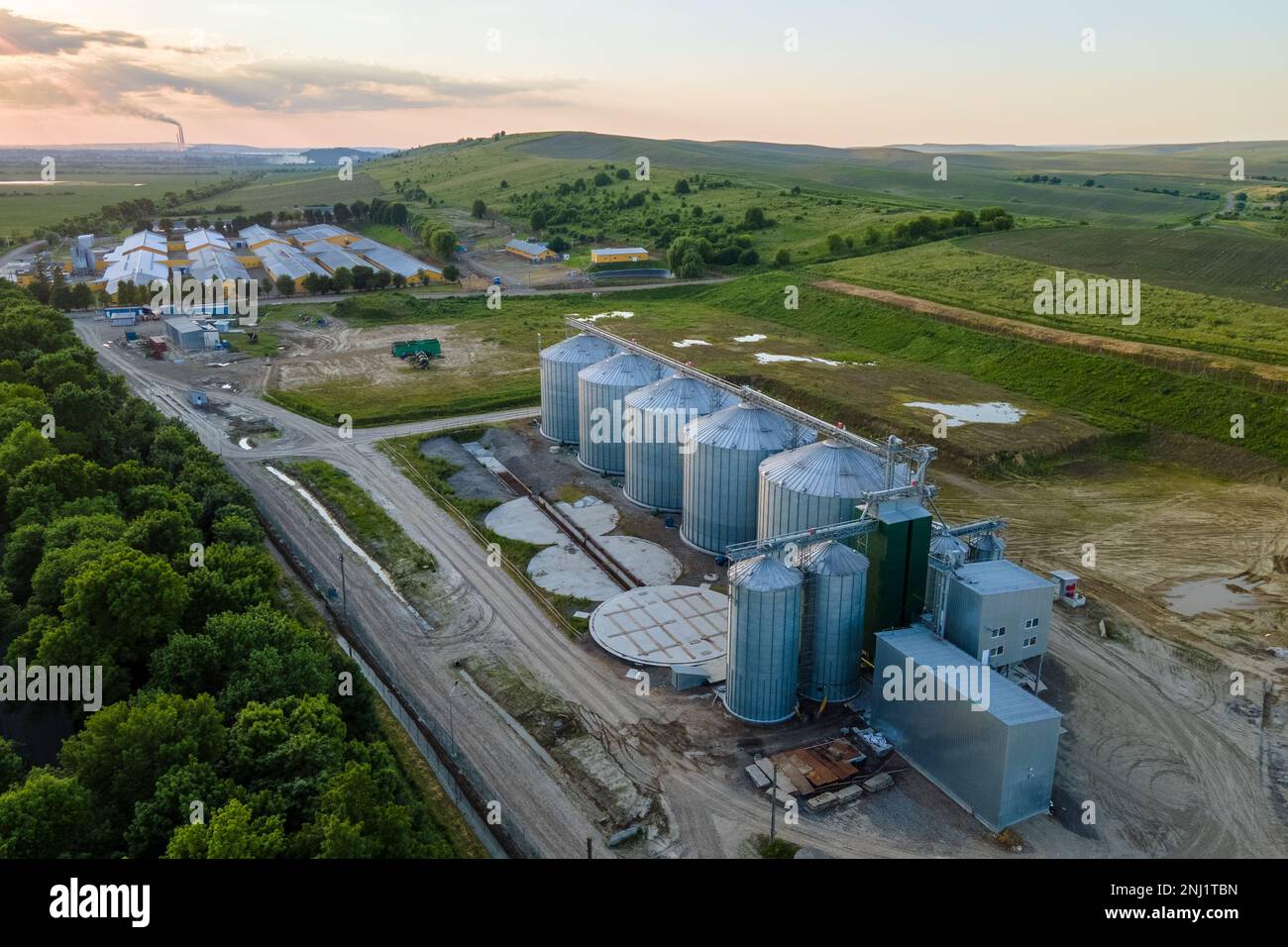 Aerial view of industrial ventilated silos for long term storage of grain and oilseed. Metal ...