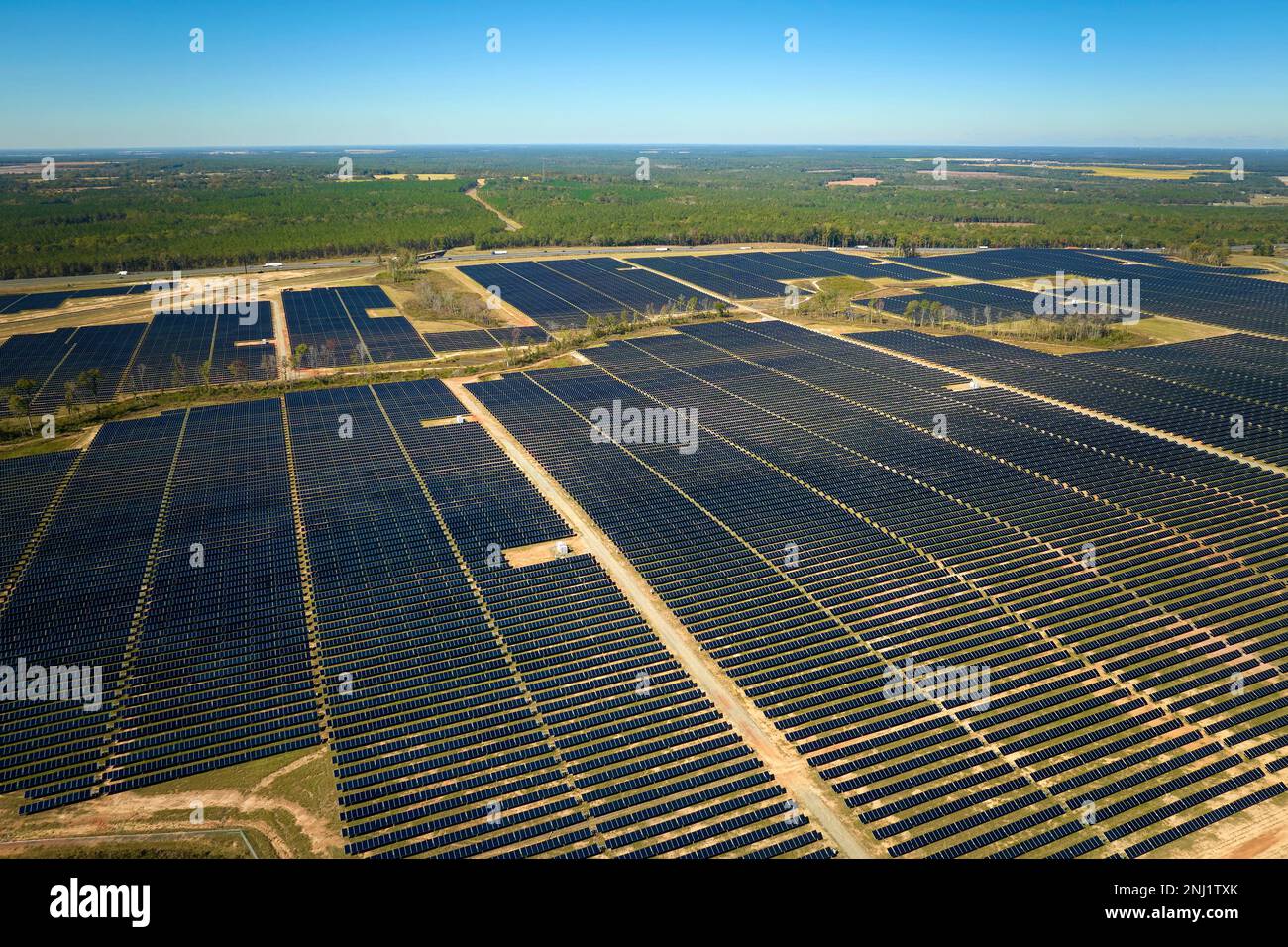 Aerial view of large sustainable electrical power plant with rows of ...