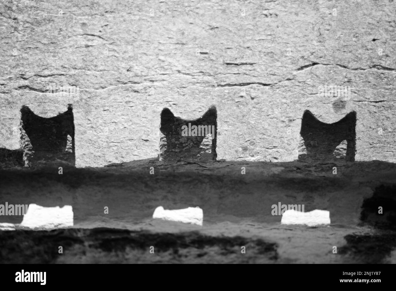 A natural stone wall with a repeating pattern as a decoration in a ...