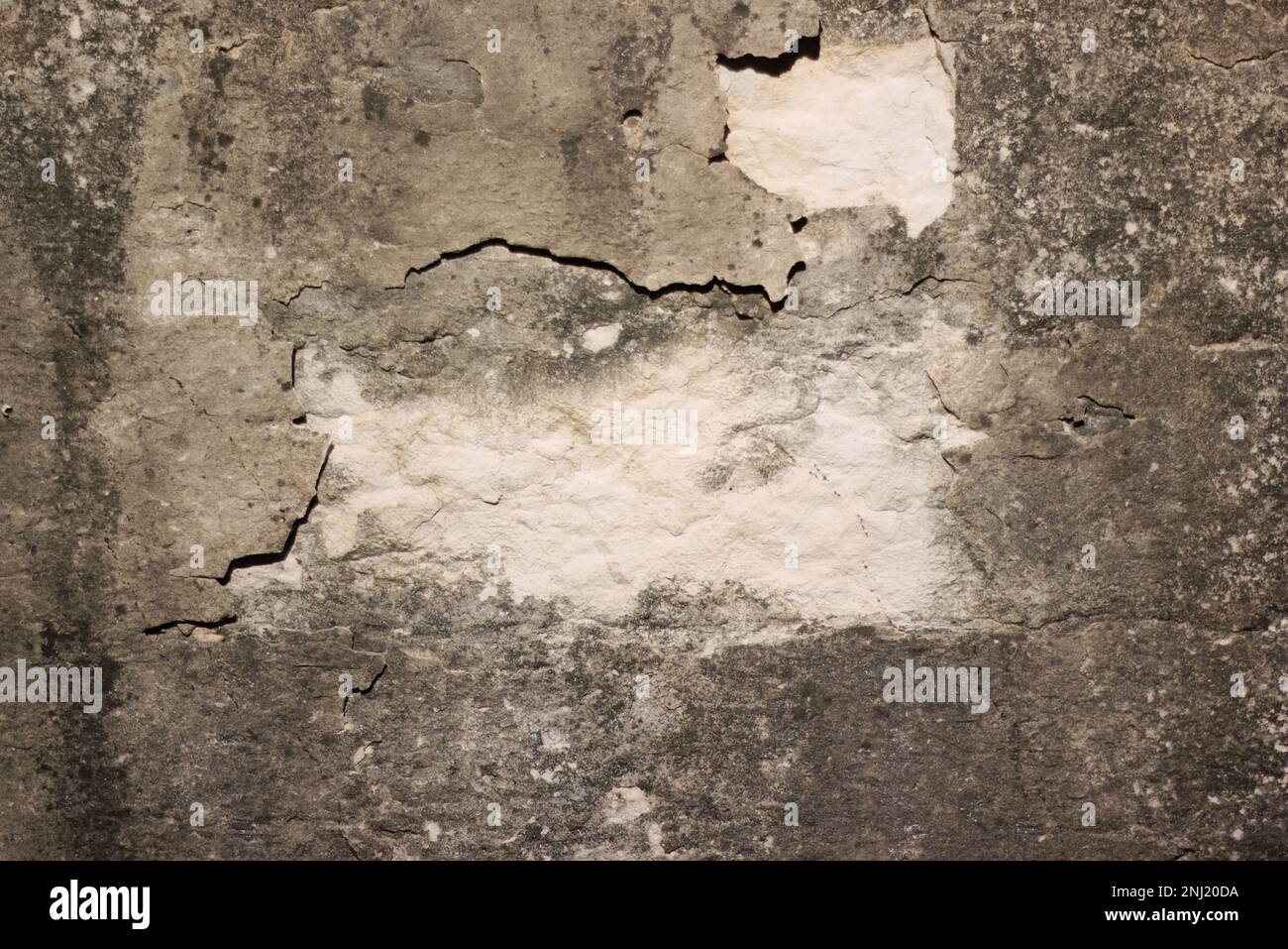 An old vintage cracked and spalling natural stone wall Stock Photo - Alamy