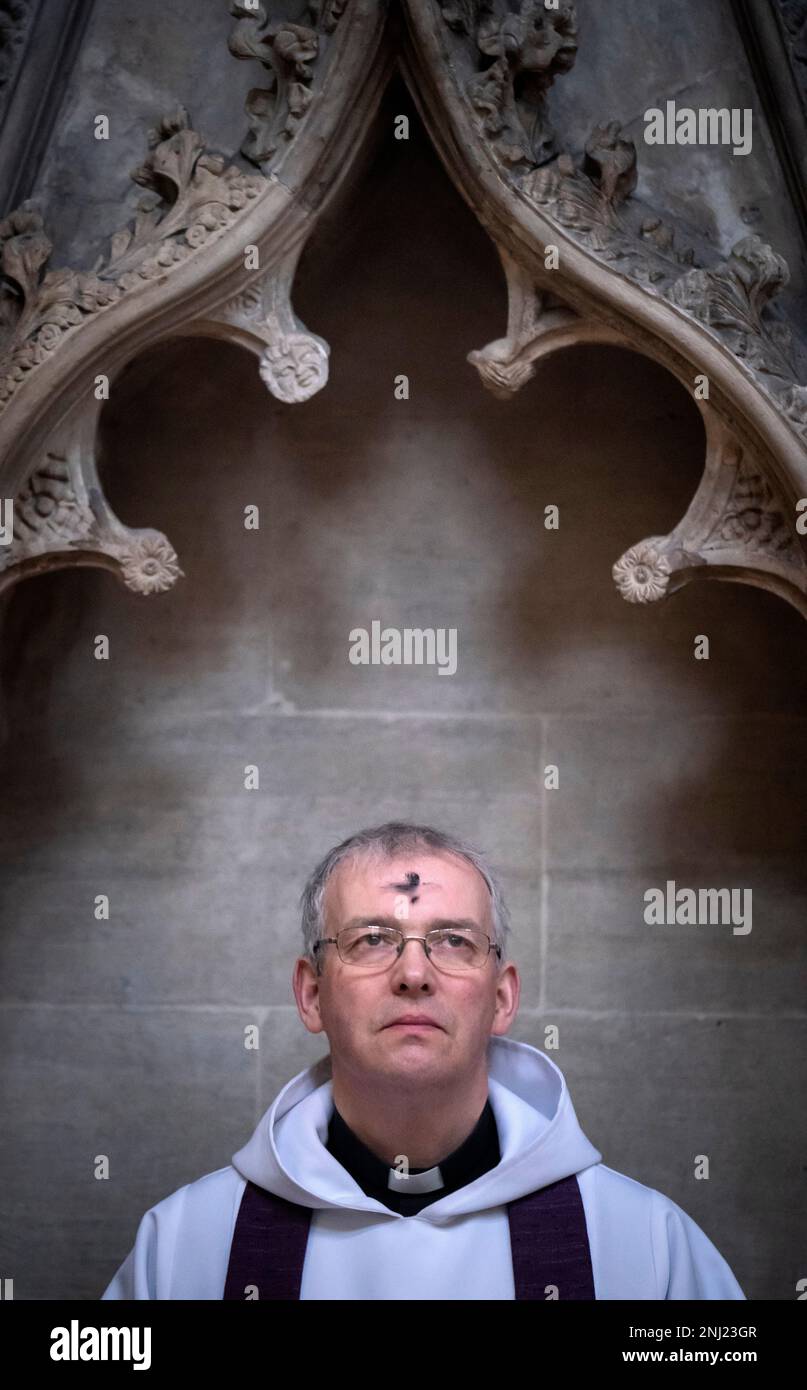 Canon Michael Gisbourne with an ash cross on his forehead, following ...