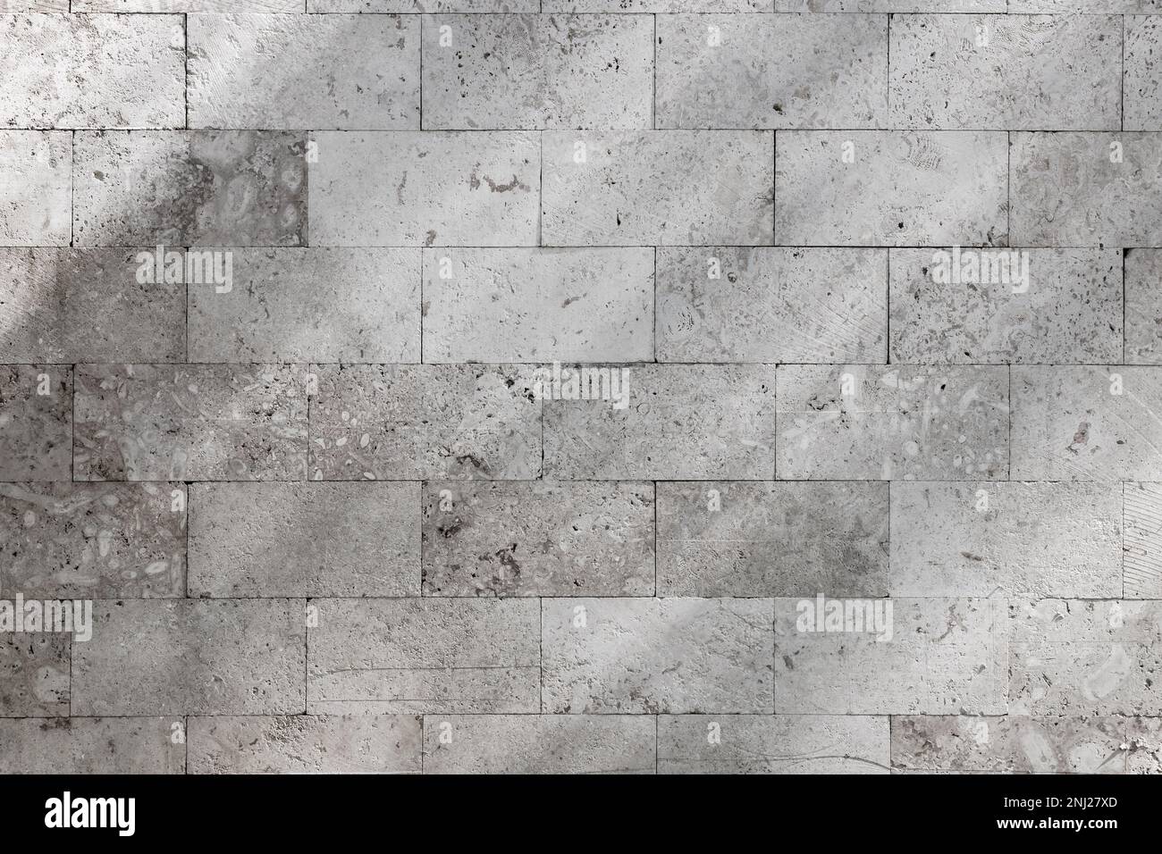 Stone wall with shadow lines pattern. Background photo texture, front ...