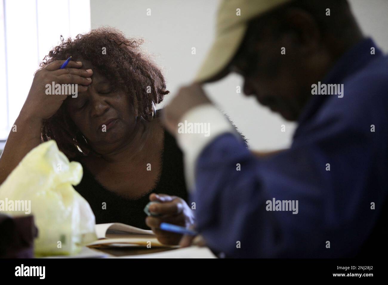 Maryann Powell (left) and her husband Donald McFarland (right) fill out ...