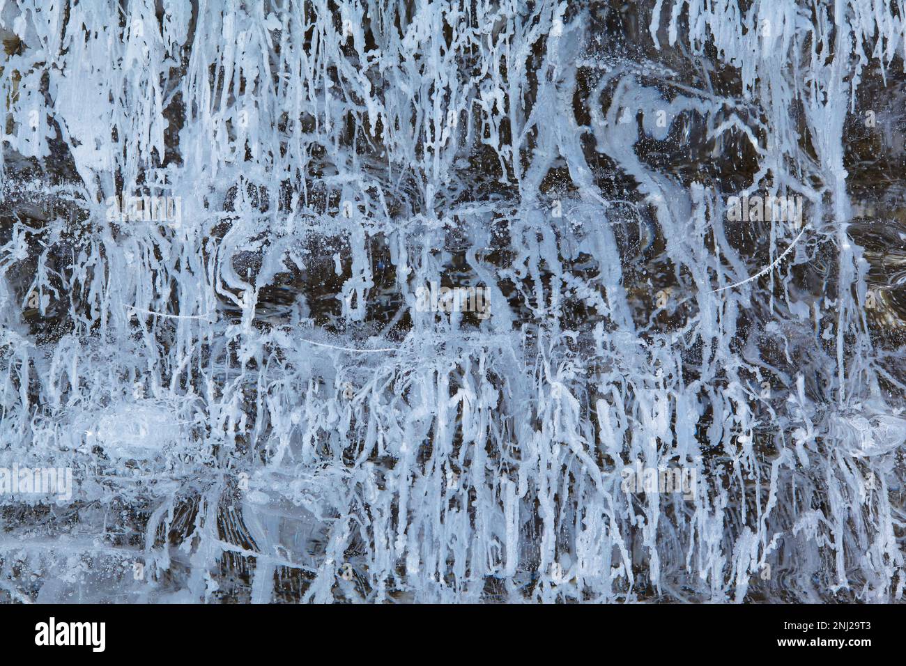 Texture of winter ice on a stone cliff. Blue natural ice background ...