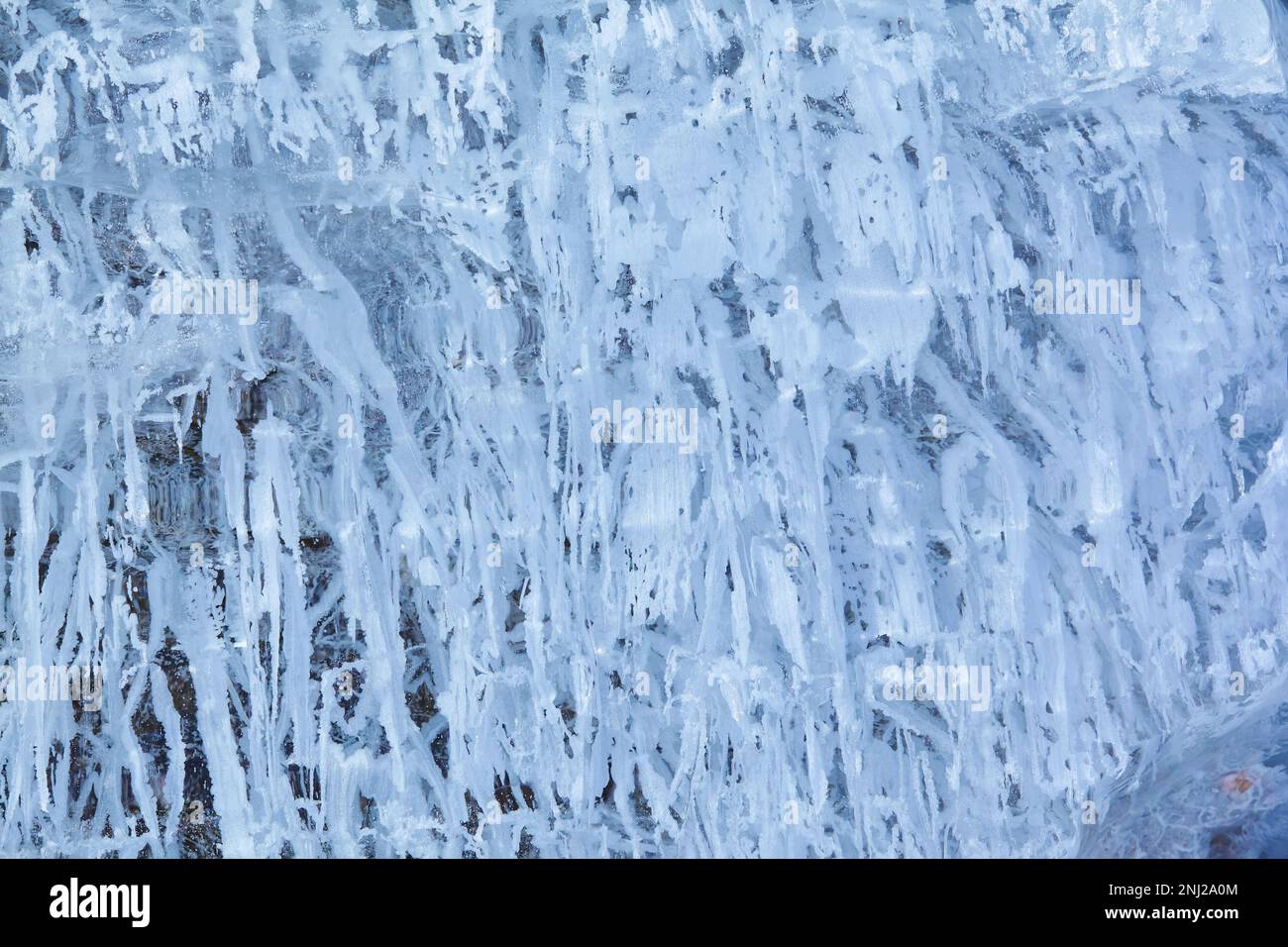 Texture of winter ice on a stone cliff. Blue natural ice background ...