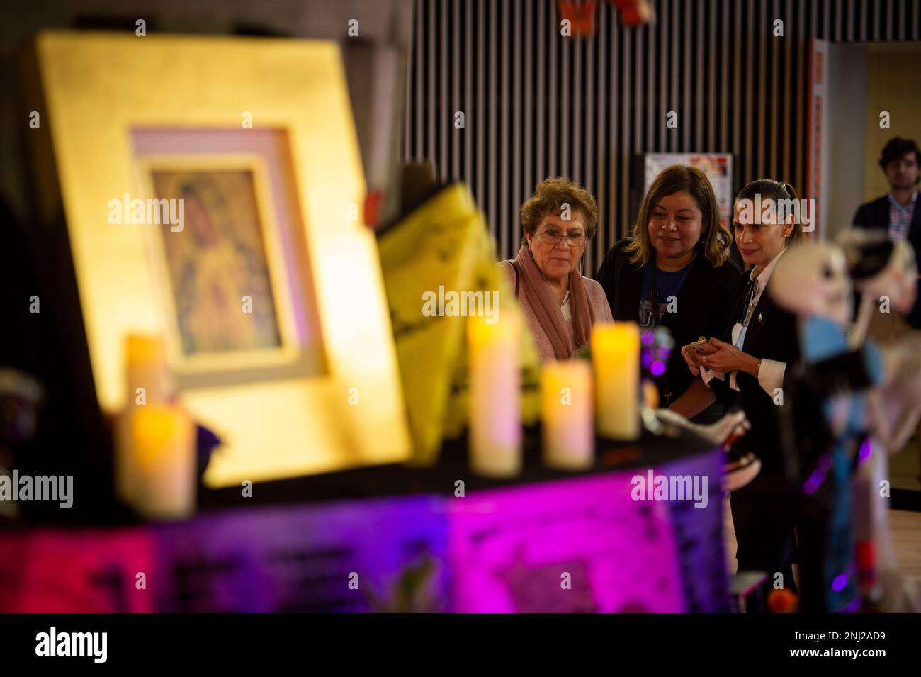 Several people look at an altar during the presentation of the Day of ...