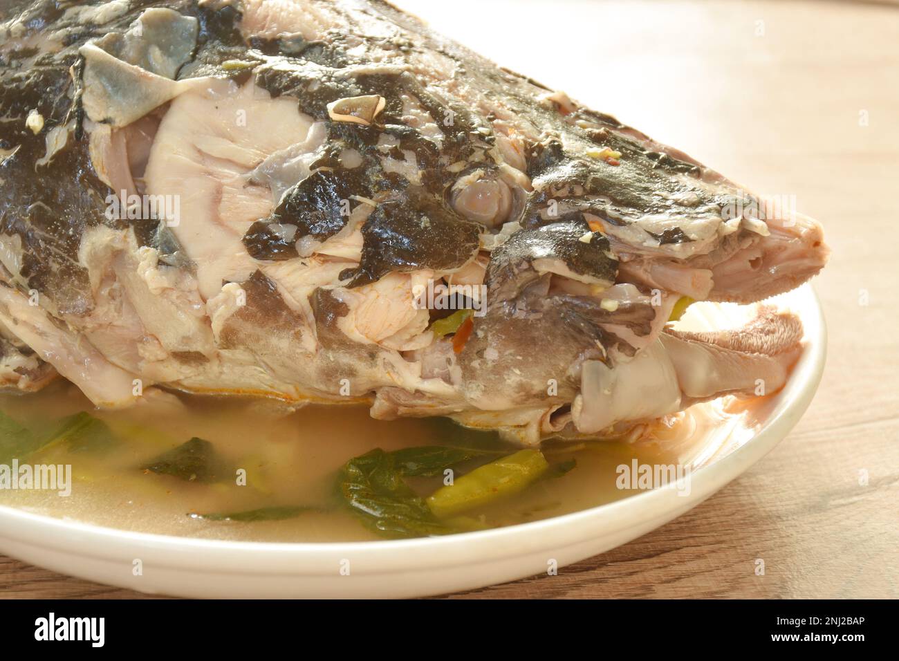 boiled Asian Redtail catfish head with chili and lemon dressings celery ...
