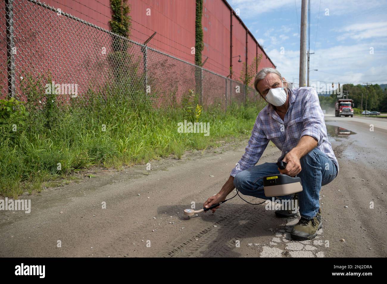 Geomicrobiologist Yuri Gorby uses a Geiger-Mueller counter to measure ...