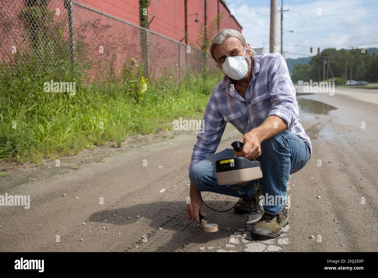 Geomicrobiologist Yuri Gorby uses a Geiger-Mueller counter to measure ...