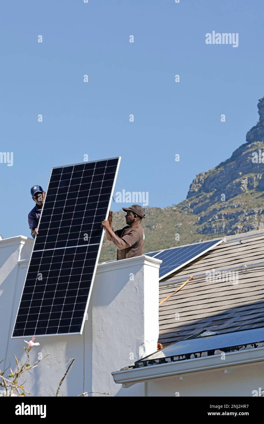 Team installing hybrid grid tied electrical installation of solar ...