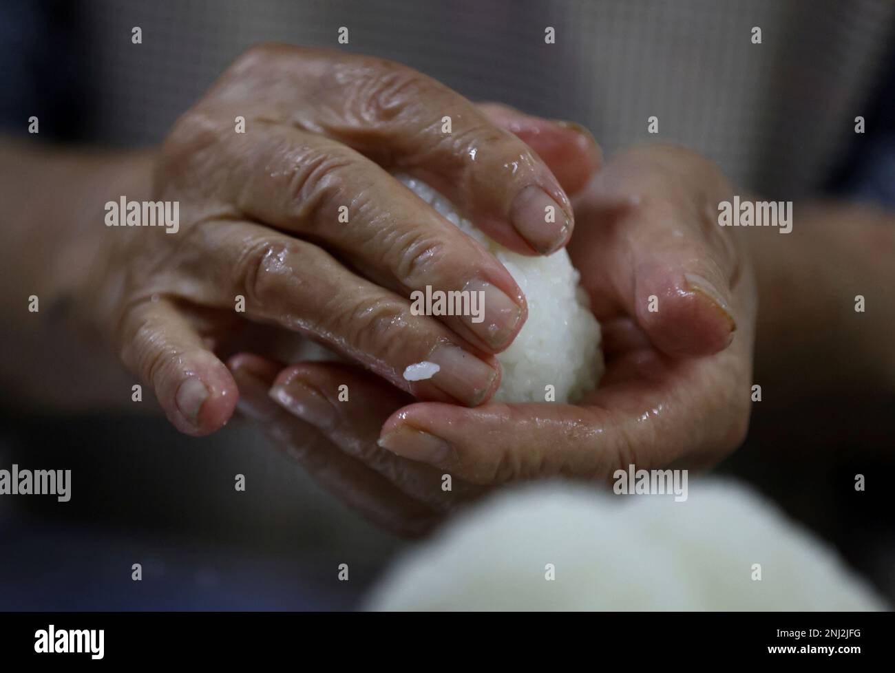 100-year-old Fumiko Yamada makes rice balls at a restaurant ...