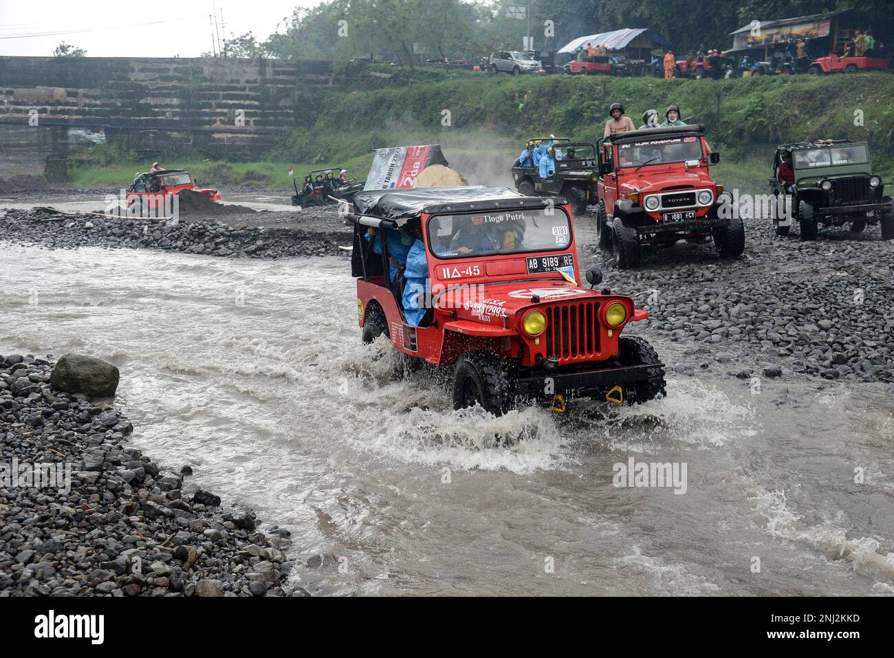 Local tourists ride off-road jeep at Kali Kuning river in the slope of ...