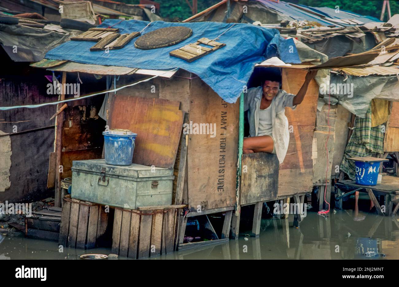 Indonesia, Jakarta. Man in slum dwelling Stock Photo - Alamy