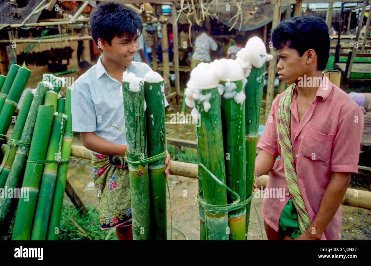 Indonesia, Sulawesi. Men sell tuak, or palm wine, the fermented sap of ...