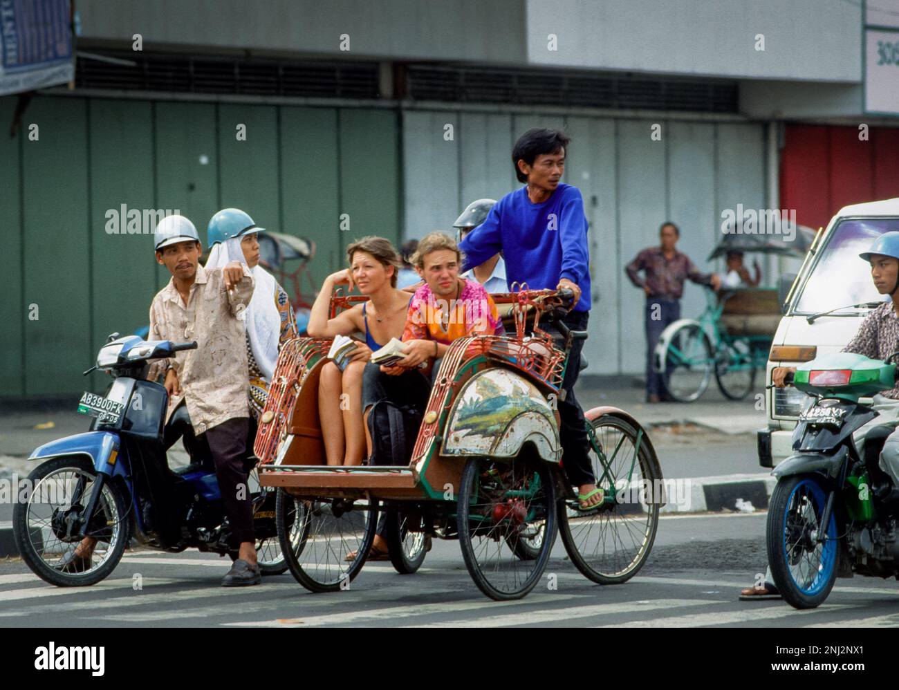 Indonesia, Yogyakarta. Tourists in a rickshaw Stock Photo - Alamy