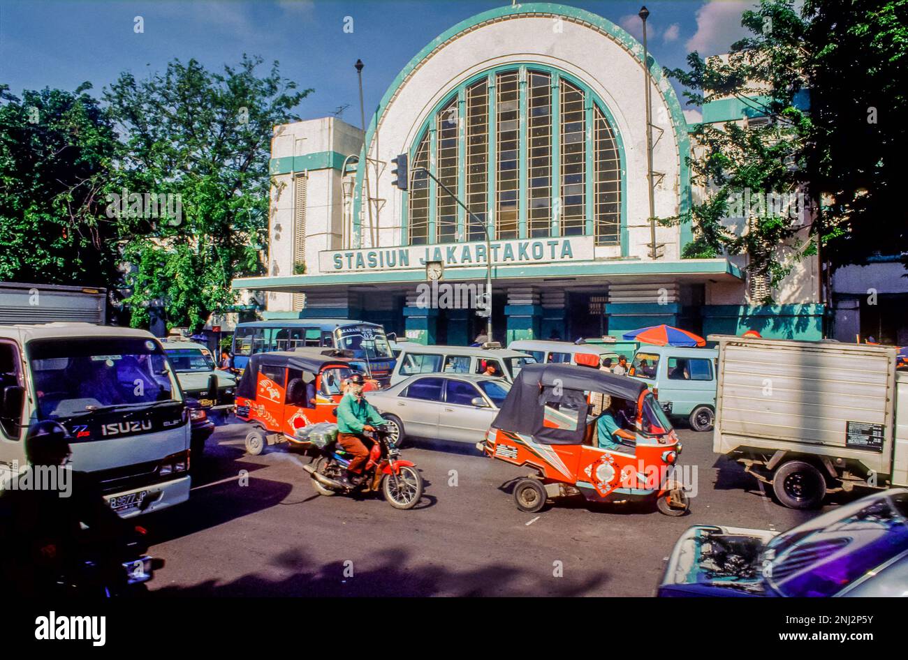 Indonesia, Jakarta. Traffic in front of railwaystation 'Stasiun Jakarta ...