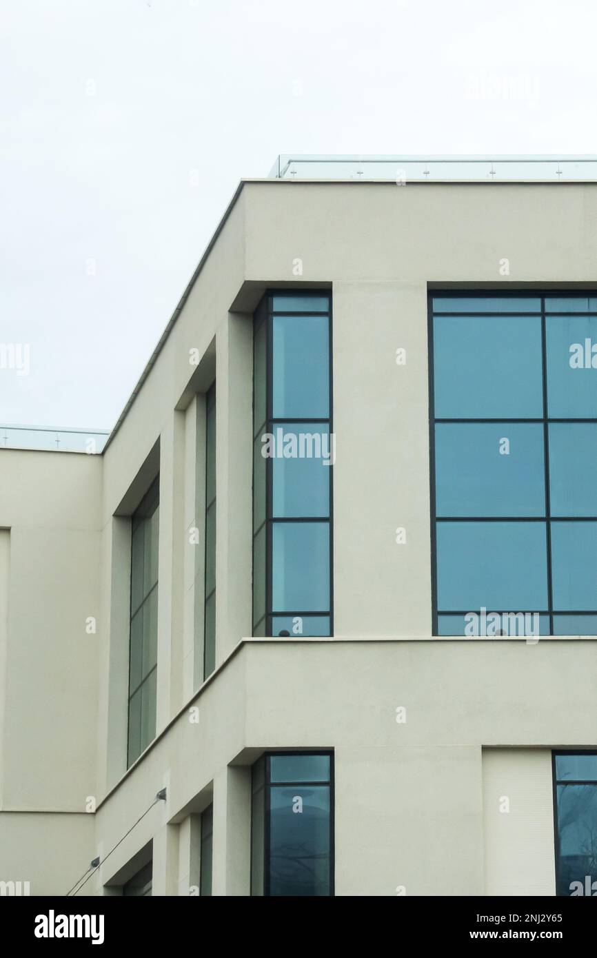 Windows on a grey building close up Stock Photo - Alamy