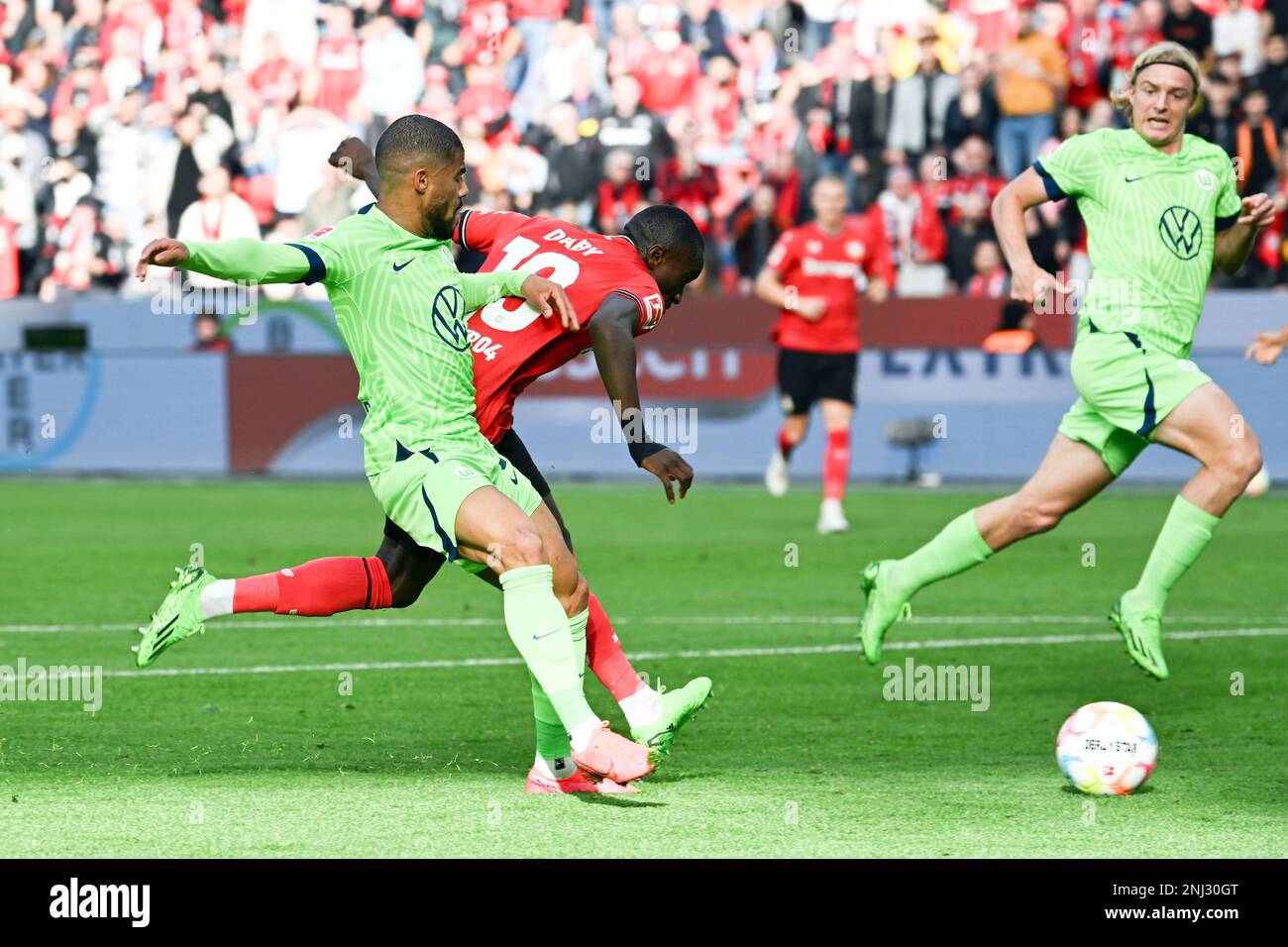 Leverkusen's Moussa Diaby, background centre, scores his side's first ...