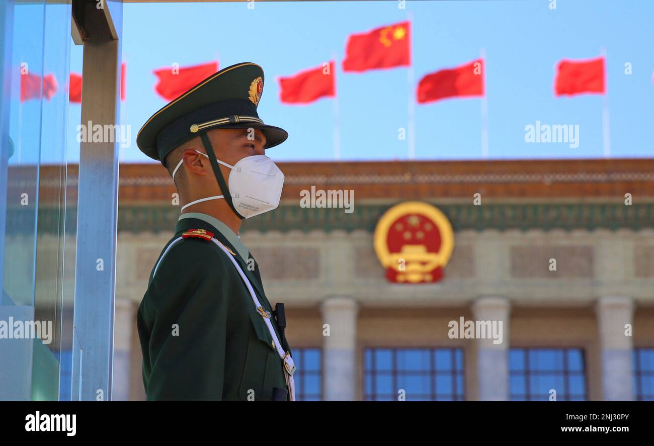 A police officer stands at the Great Hall of the People where the ...