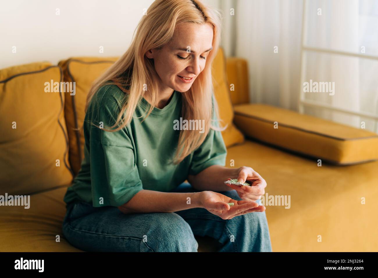 The woman is taking antidepressants. Care and health Stock Photo - Alamy