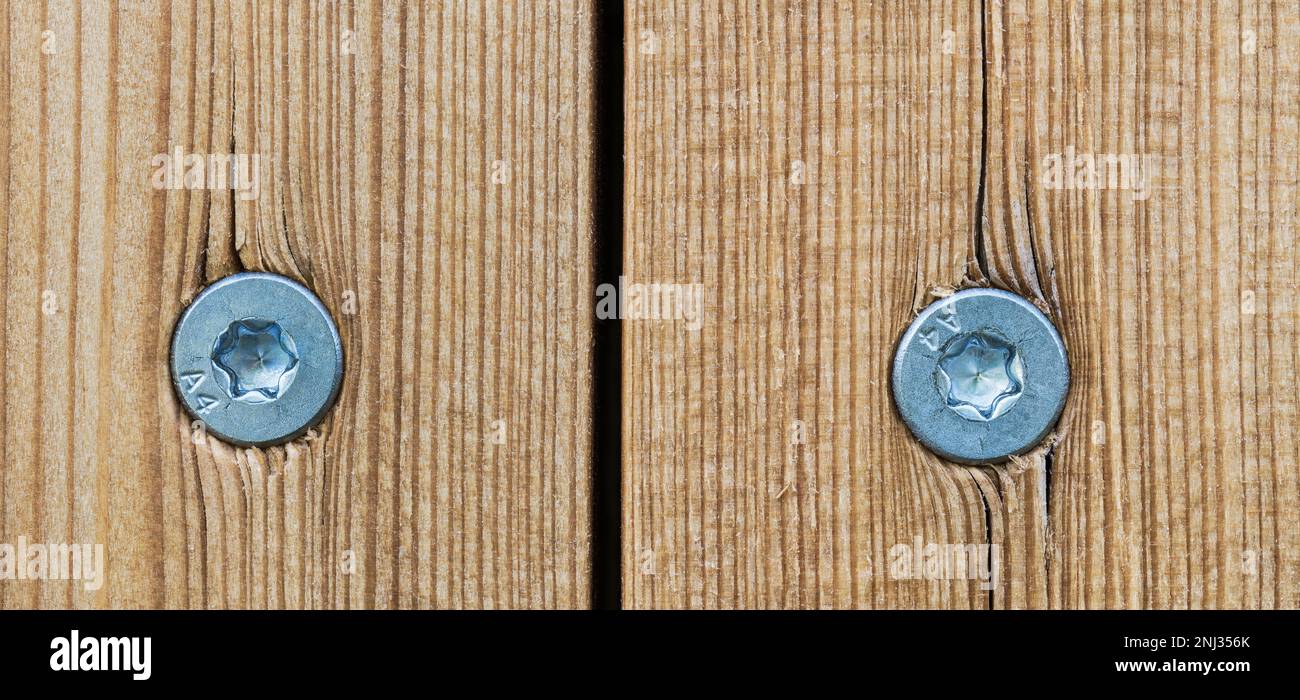 Stainless steel self-tapping wood screws in a wall of natural larch ...