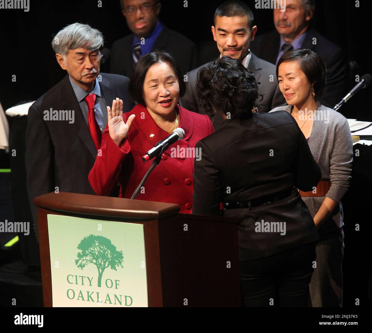 Oakland's new mayor Jean Quan (in red) is inaugurated by city clerk ...