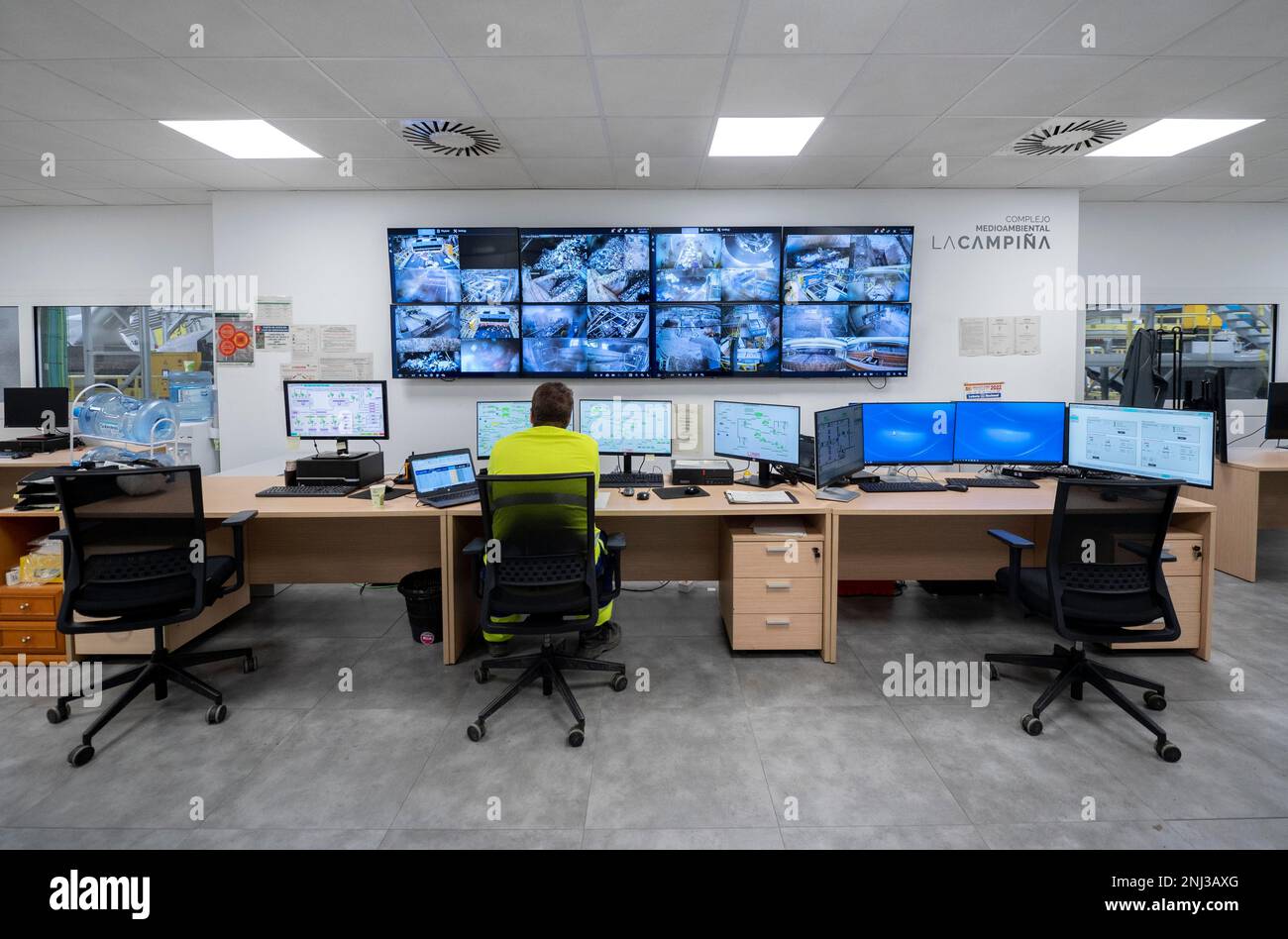 A technician in the control room of the waste separation platform at ...