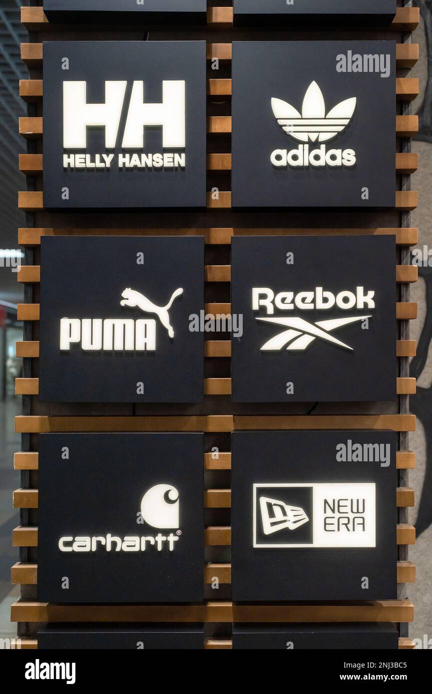 Logos of popular footwear and clothing brands in the interior of a ...
