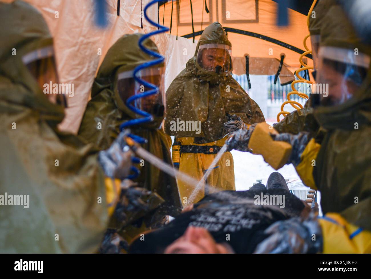 The 61st Medical Squadron begin the decon process with a patient during ...