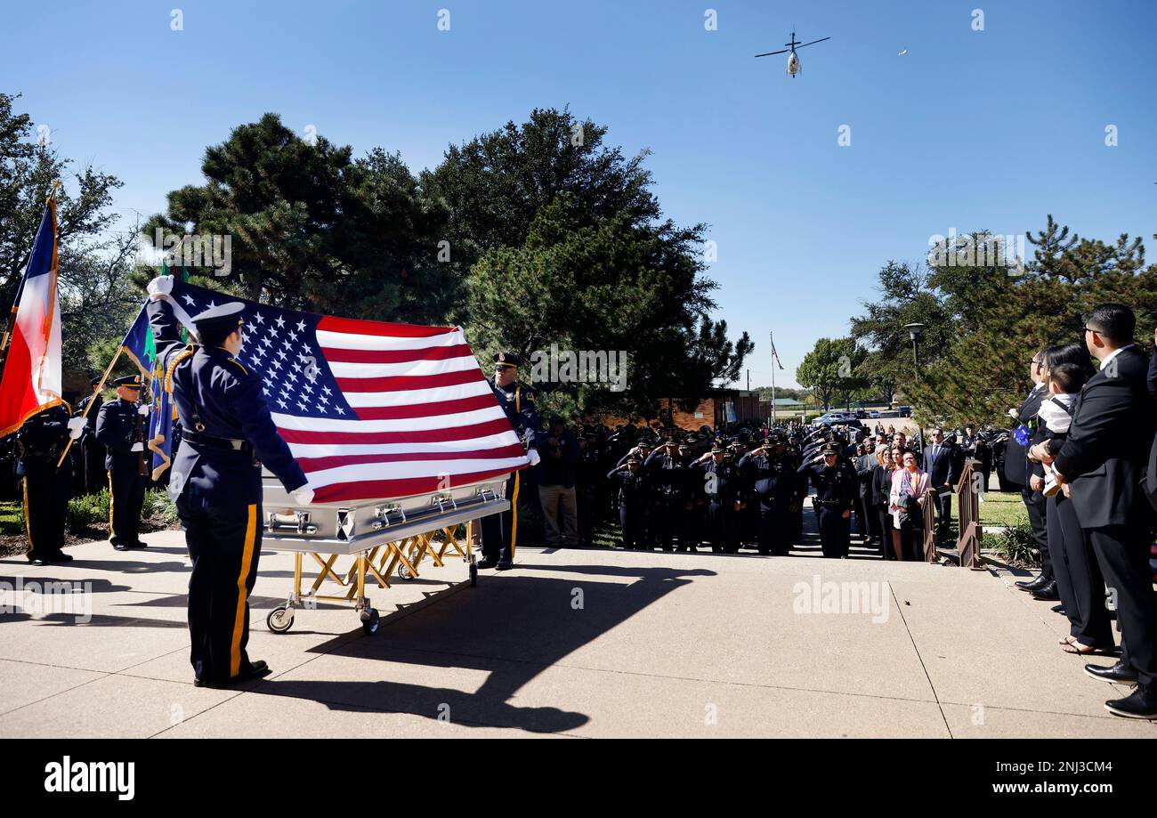 The Dallas Police helicopter performs a flyover as the U.S. flag is ...