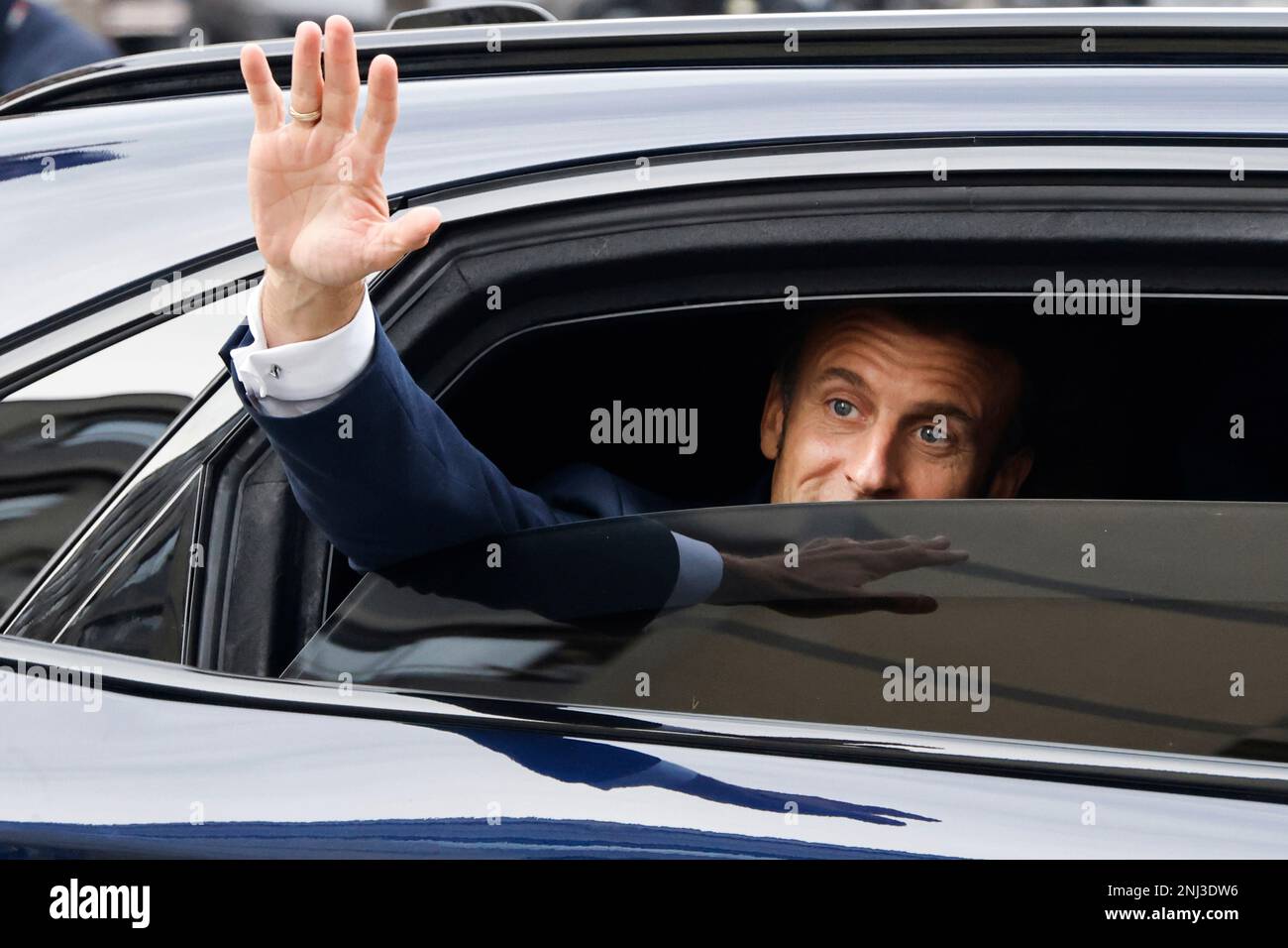 French President Emmanuel Macron waves as he leaves in a car after a ...
