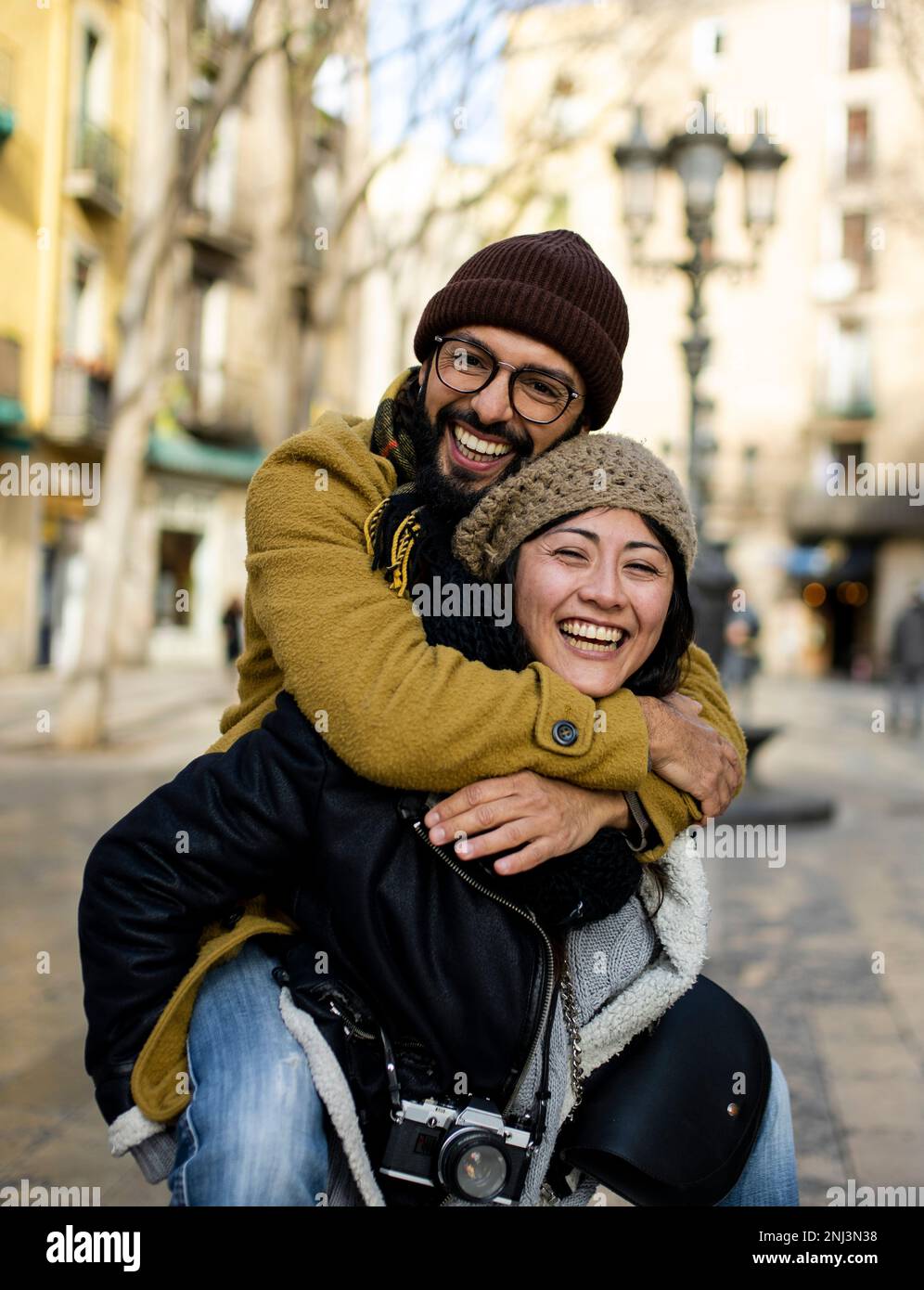 Couple of tourists having fun walking on city street at holiday - Happy ...