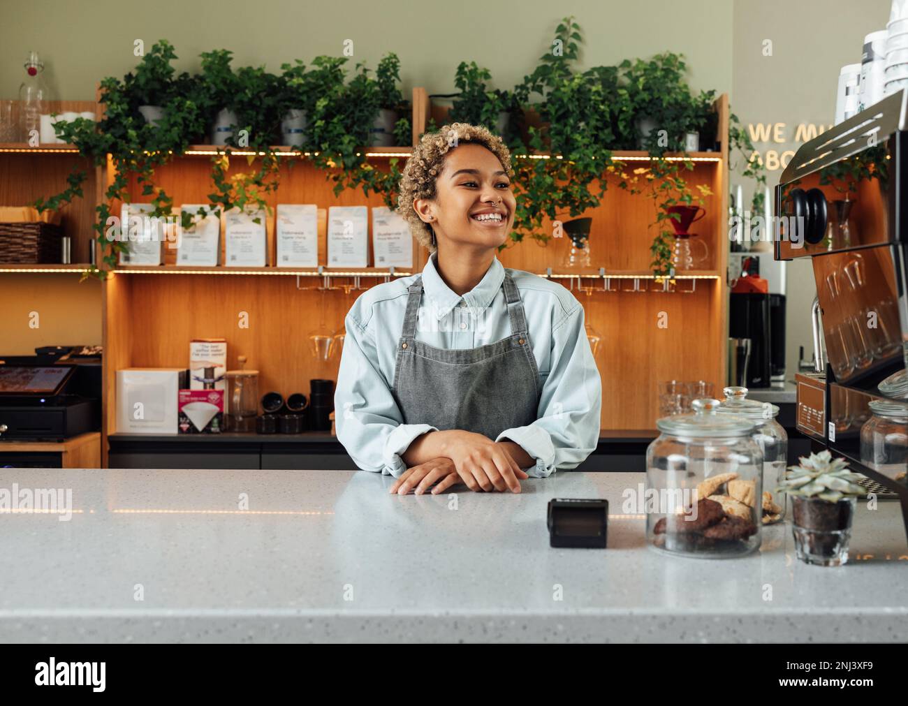 Happy young female barista hi-res stock photography and images - Alamy