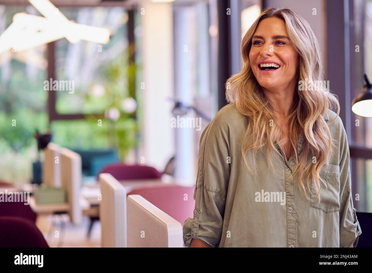 Mature businesswoman standing partition hi-res stock photography and ...