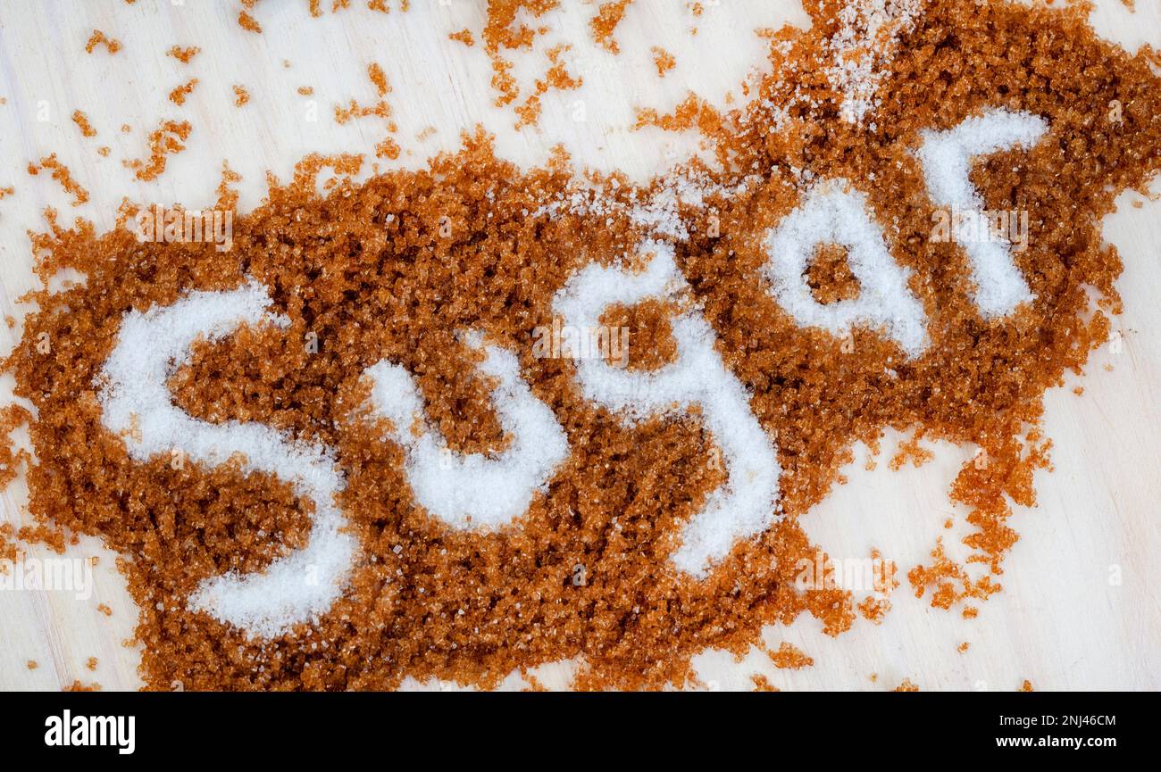 Sugar written in white sugar on brown sugar Stock Photo - Alamy