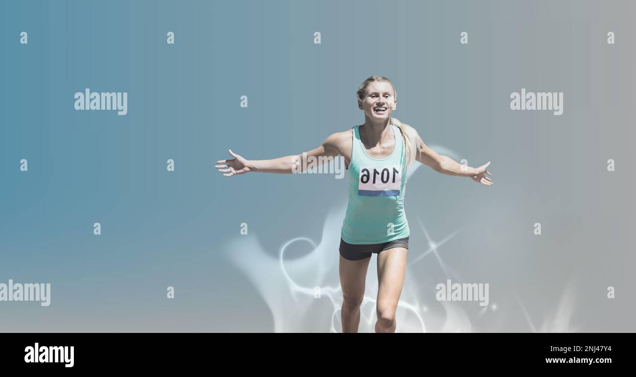 Composition of smiling female athlete running against blue light trails on blue background ...
