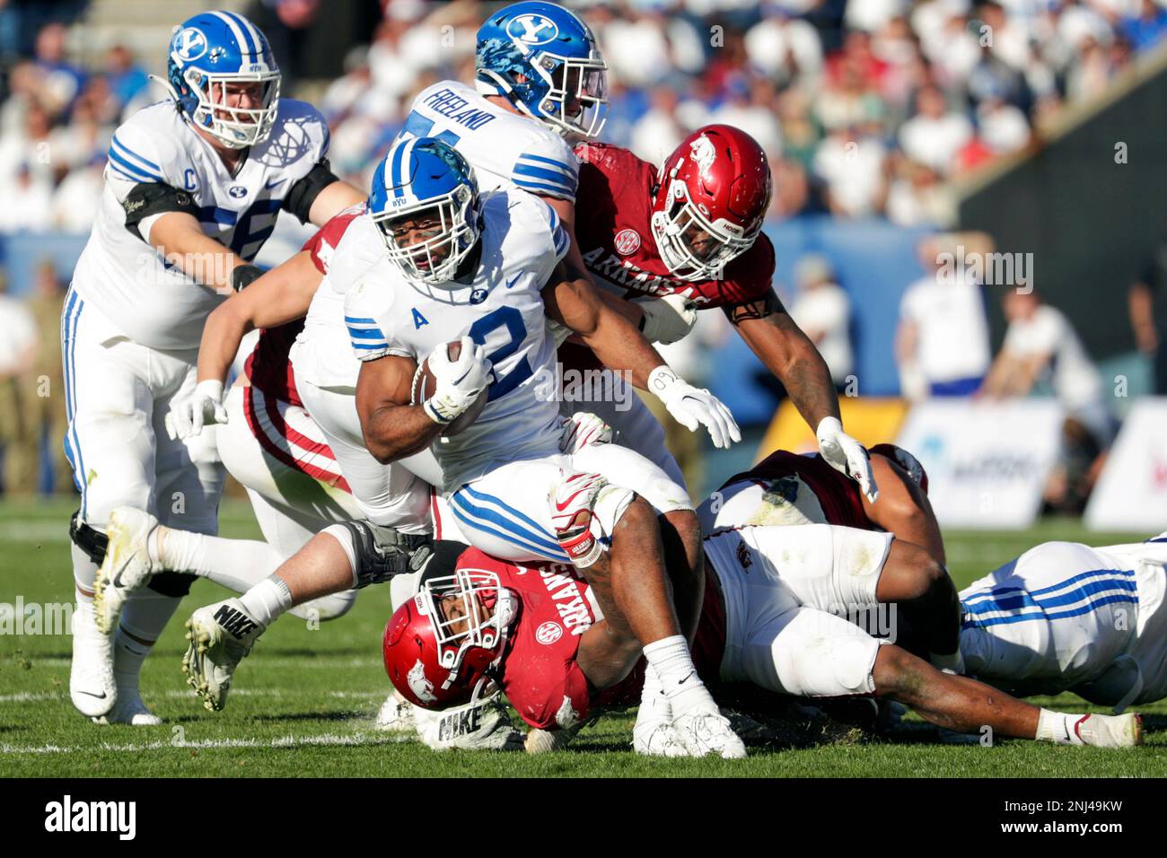 BYU running back Christopher Brooks (2) is tackled by Arkansas' Chris ...