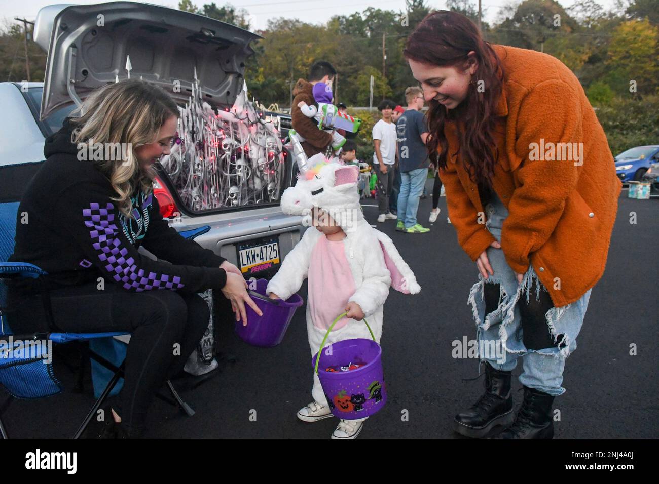 Kalani Coley, dressed as a unicorn, with her mother, Jen Coley, stops ...