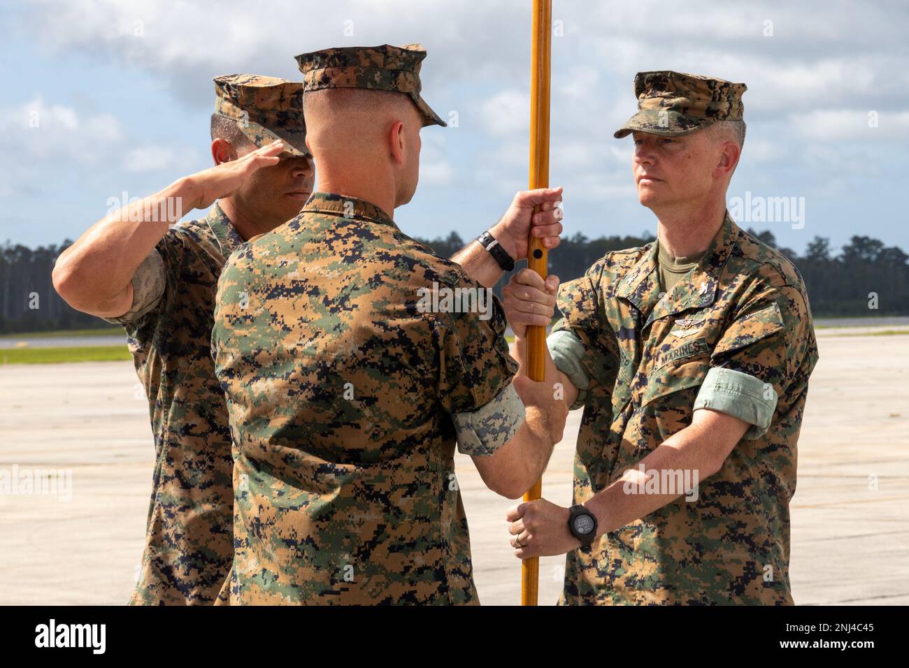 U.S. Marine Corps Col. Mikel R. Huber, right, passes the Marine Corps ...