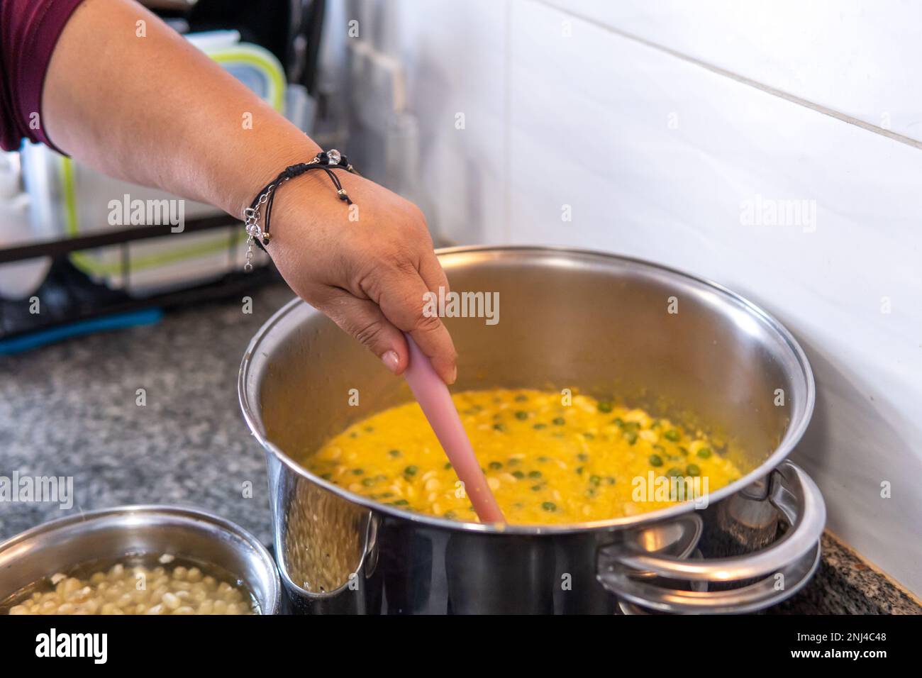 Women's hands stirring the soup with legumes Stock Photo - Alamy