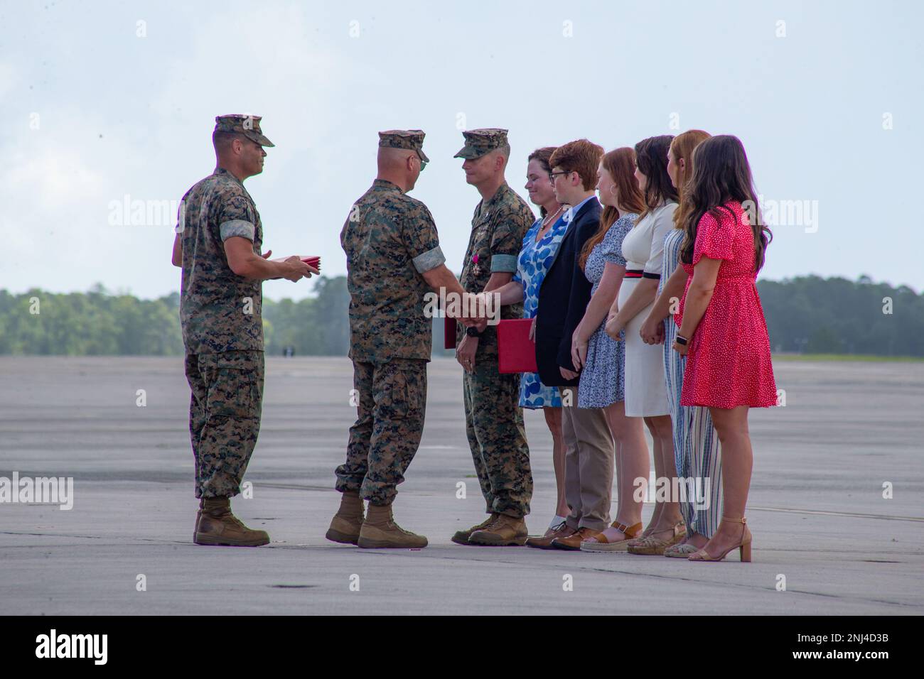 U.S. Marine Corps Col. Mikel Huber stands next to his family, as they ...