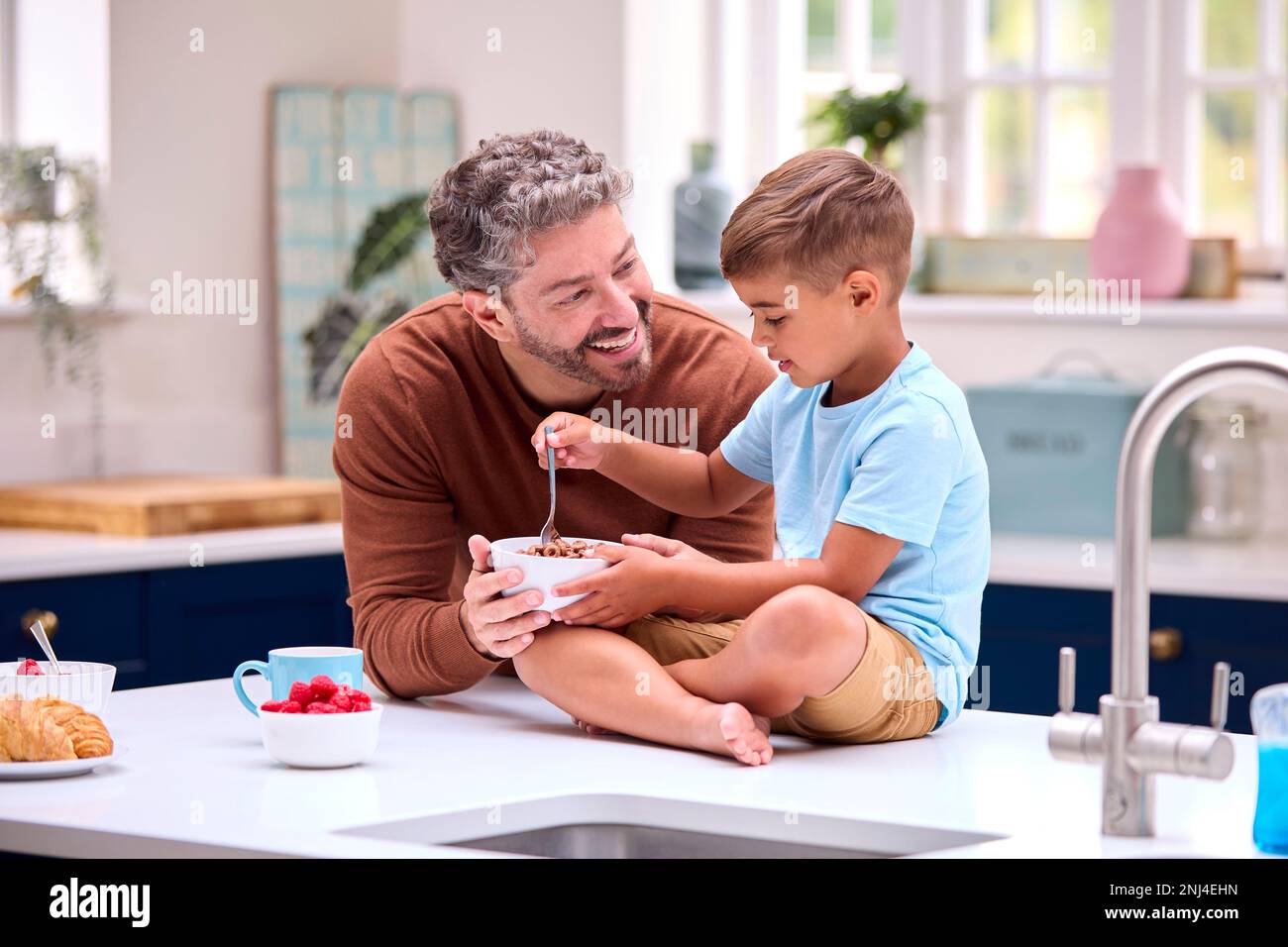 Boy sitting on counter hi-res stock photography and images - Alamy