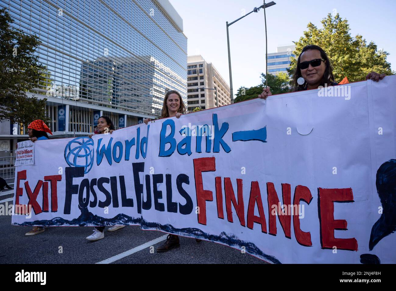 Climate activists march outside World Bank headquarters during the ...