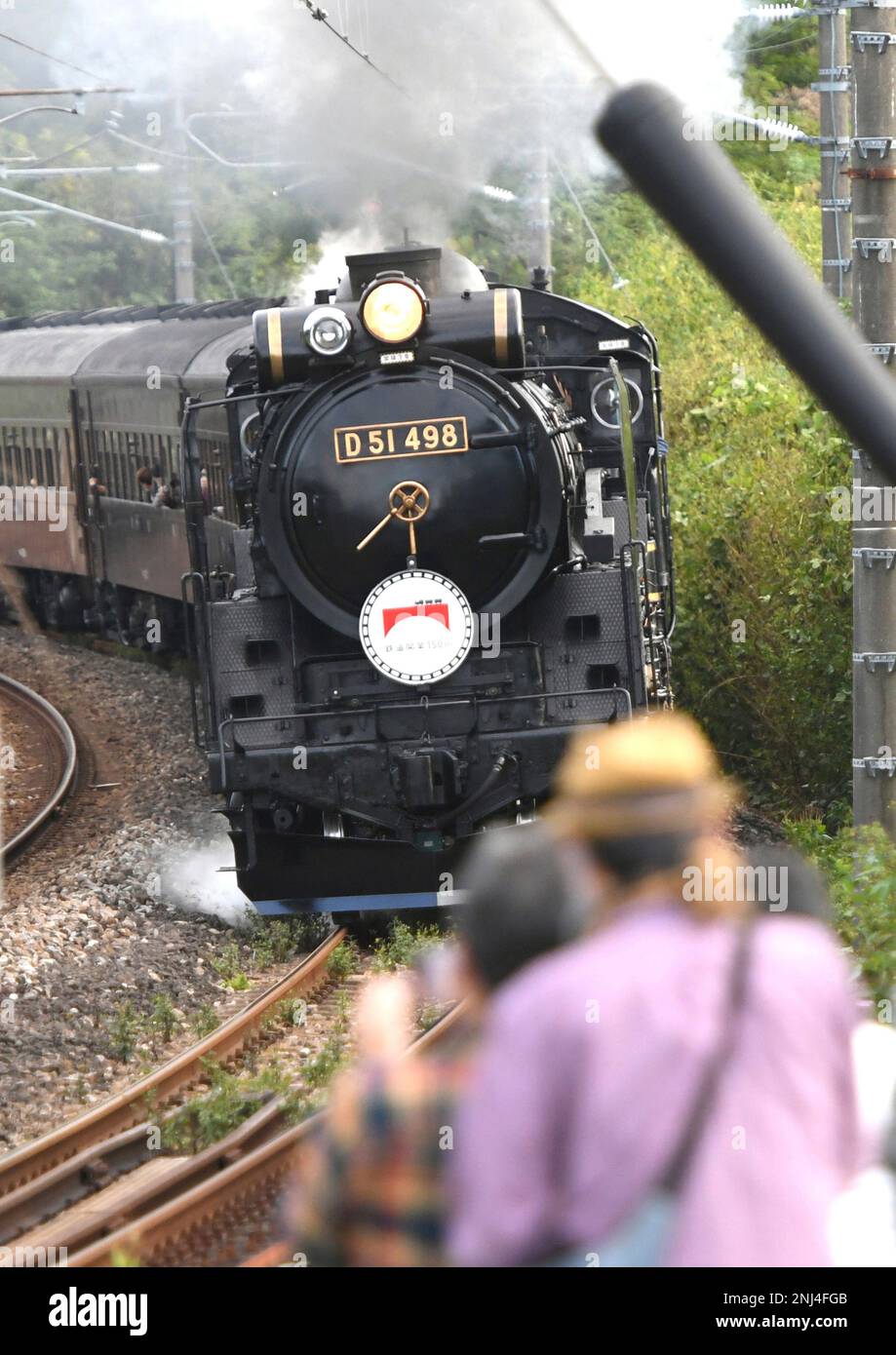 Railroad fans take photos of an SL( steam locomotive) train running ...